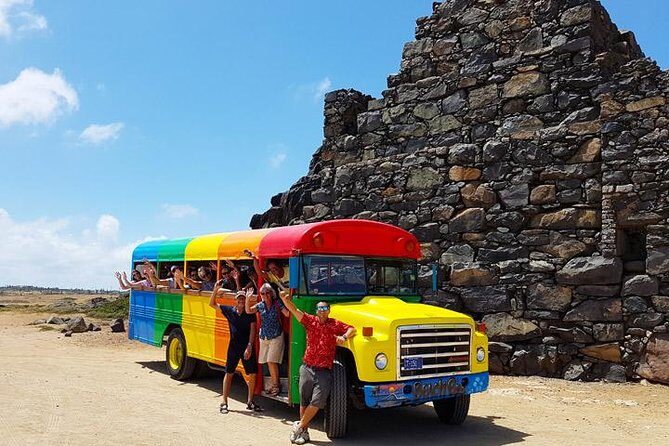 Colorful Beach Bus Sightseeing Tour of Aruba - Key Points