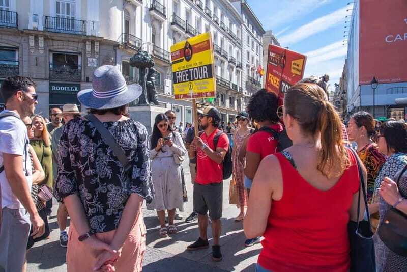 Madrid Essential Walking Tour with Churros, Drink & Market - Starting at Puerta del Sol: The Heart of Madrid