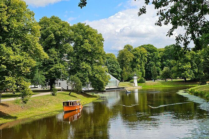 Riga: Evening or Sunset Boat Tour with Drink and Audio Guide - The Sum Up