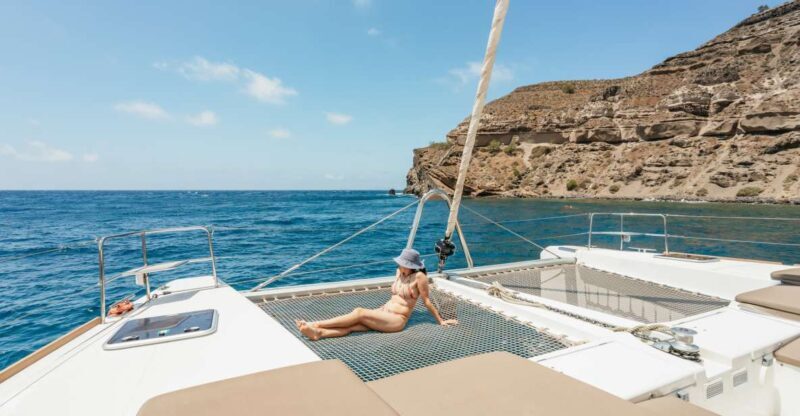 Santorini: Luxury Catamaran Day Trip with Meal and Open Bar - Food & Drinks: Greek Cuisine at Sea
